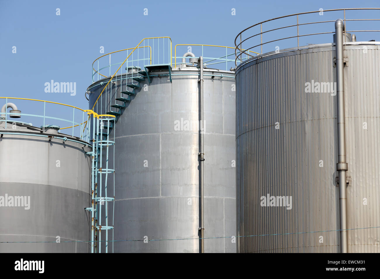 Storage tanks in a chemical plant against blue sky Stock Photo - Alamy