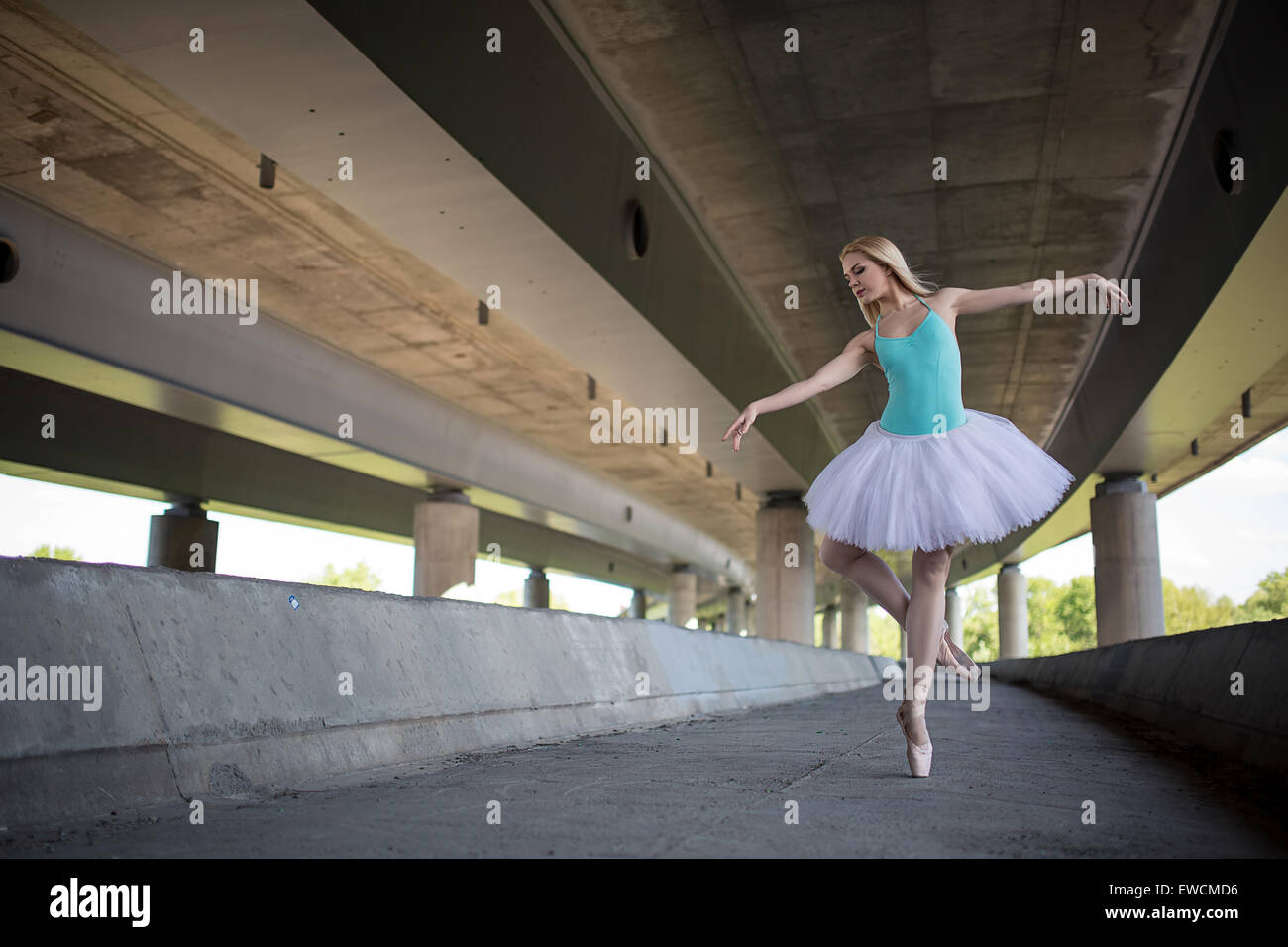 Graceful ballerina doing dance exercises on a concrete bridge Stock ...