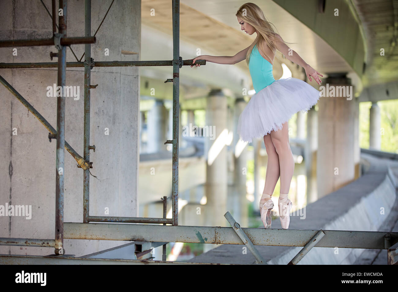 Graceful ballerina doing dance exercises on a concrete bridge Stock ...