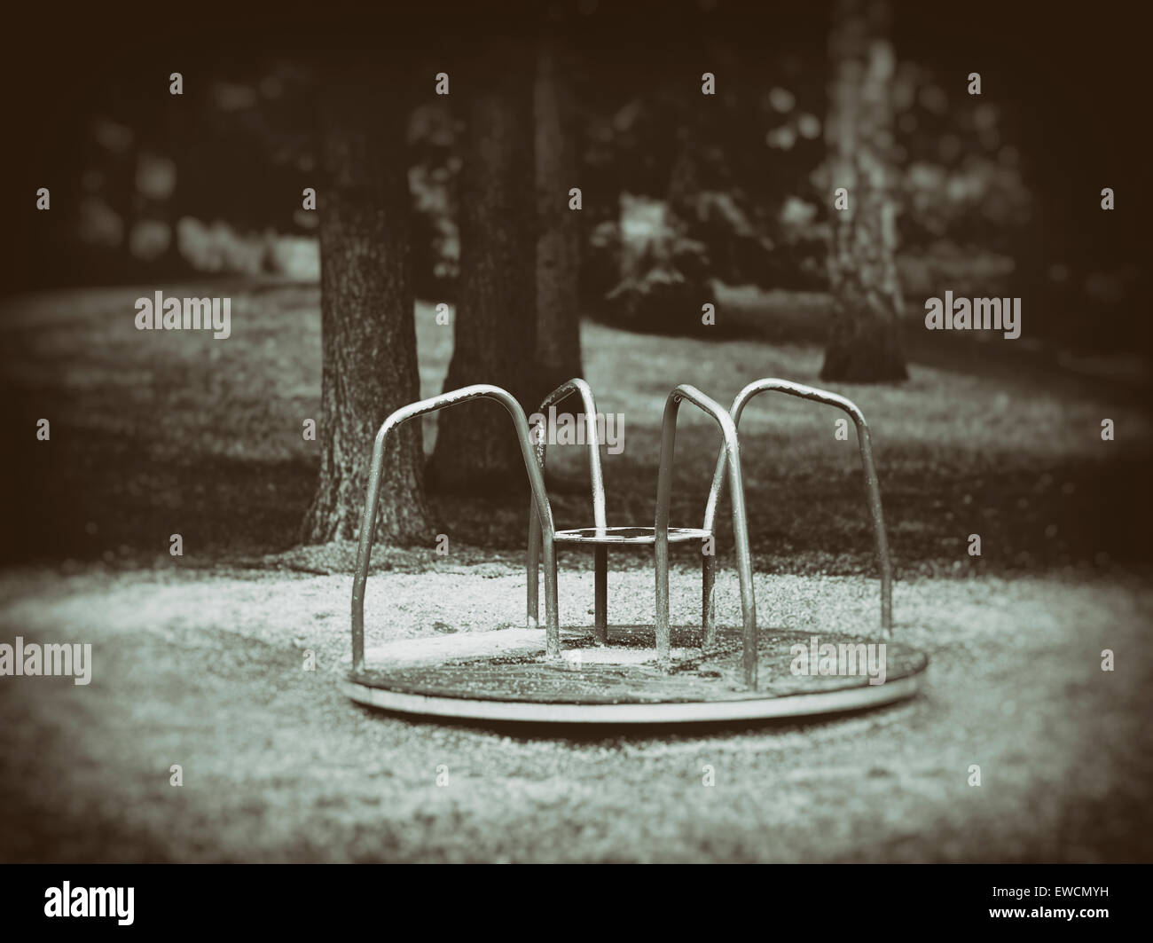 Empty children's roundabout in the playground, sinister feel, tinted ...