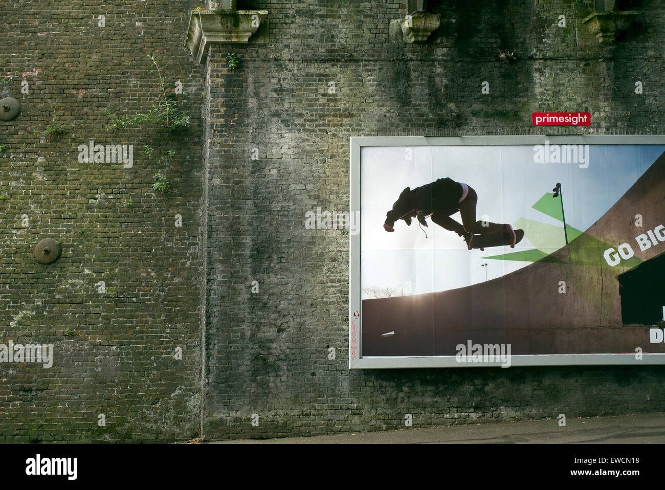 billboard poster on brick wall, Brighton UK Stock Photo - Alamy