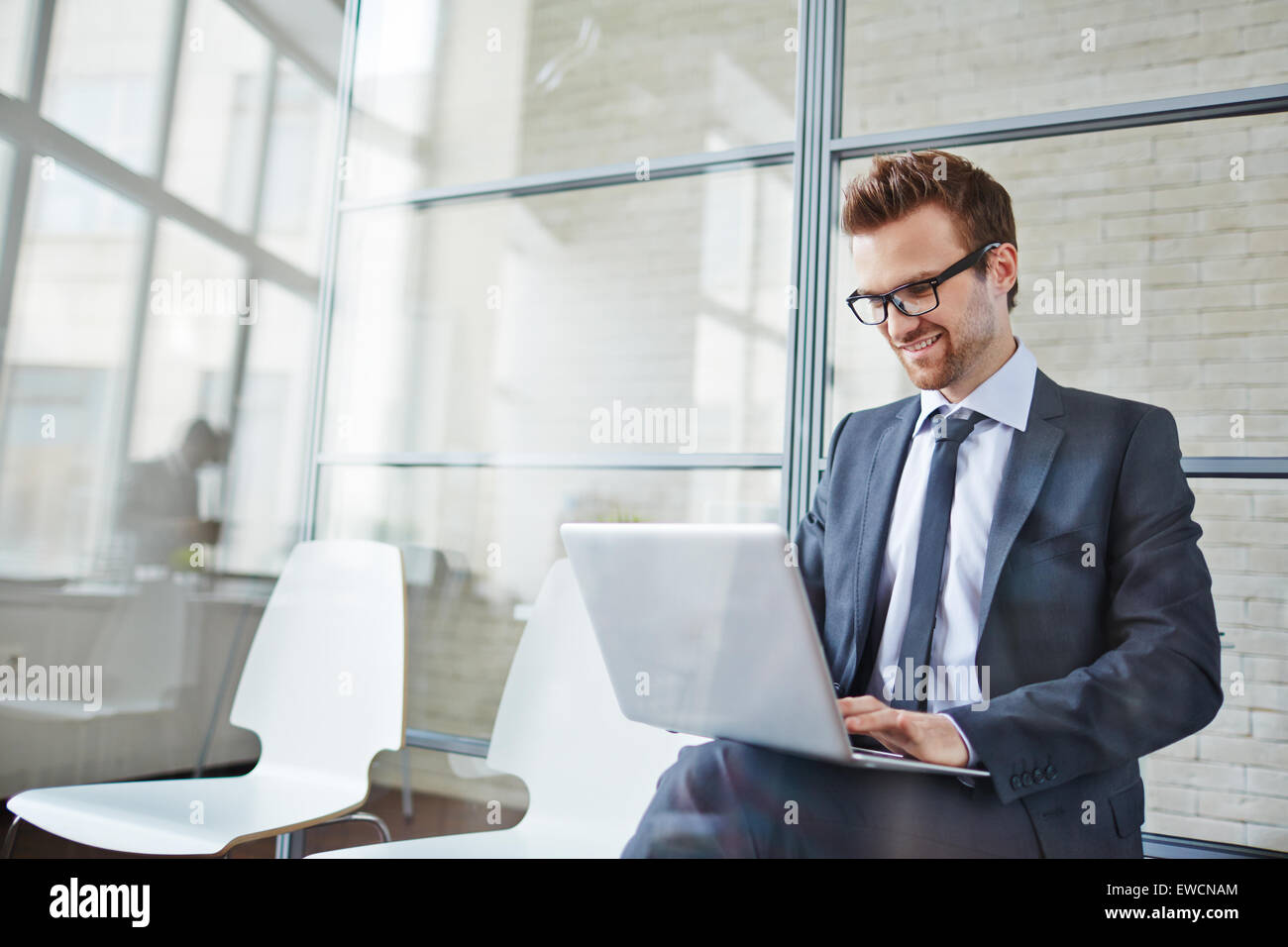 Successful employee working with laptop in office Stock Photo - Alamy