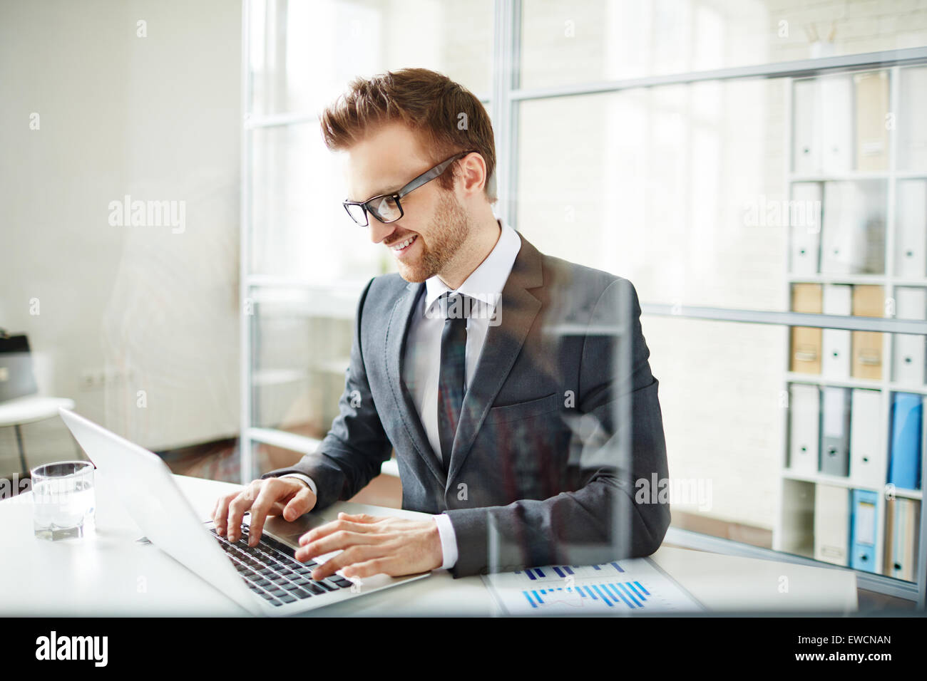 Successful young businessman networking in office Stock Photo - Alamy