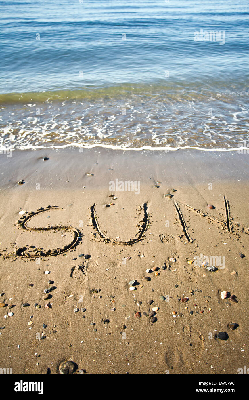 sand on the beach with sea water and sun writing in the sand Stock ...