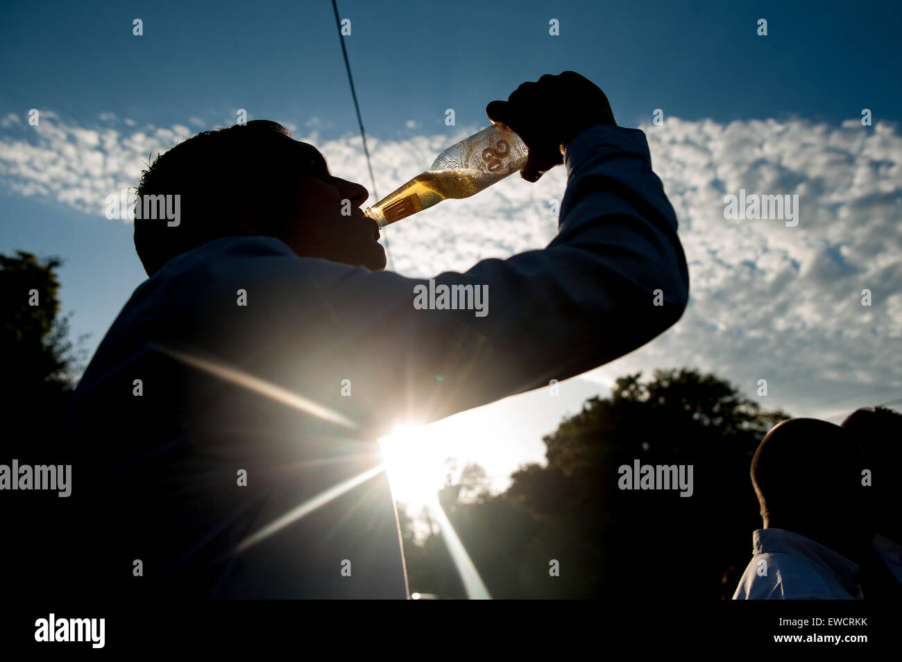 A silhouette of a man drinking a beer Stock Photo - Alamy