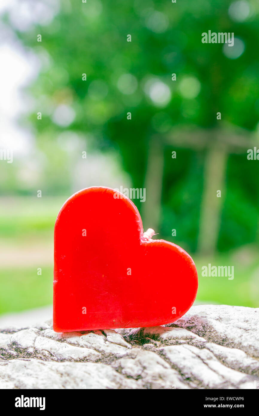 Red heart shapes on a rock in the garden Stock Photo - Alamy