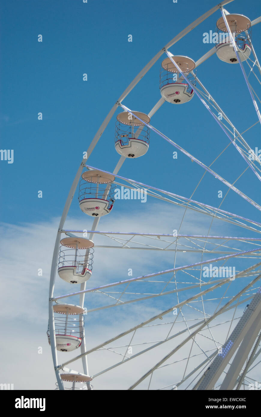 Big Wheel fun ride pods against a vivid blue sky Stock Photo - Alamy