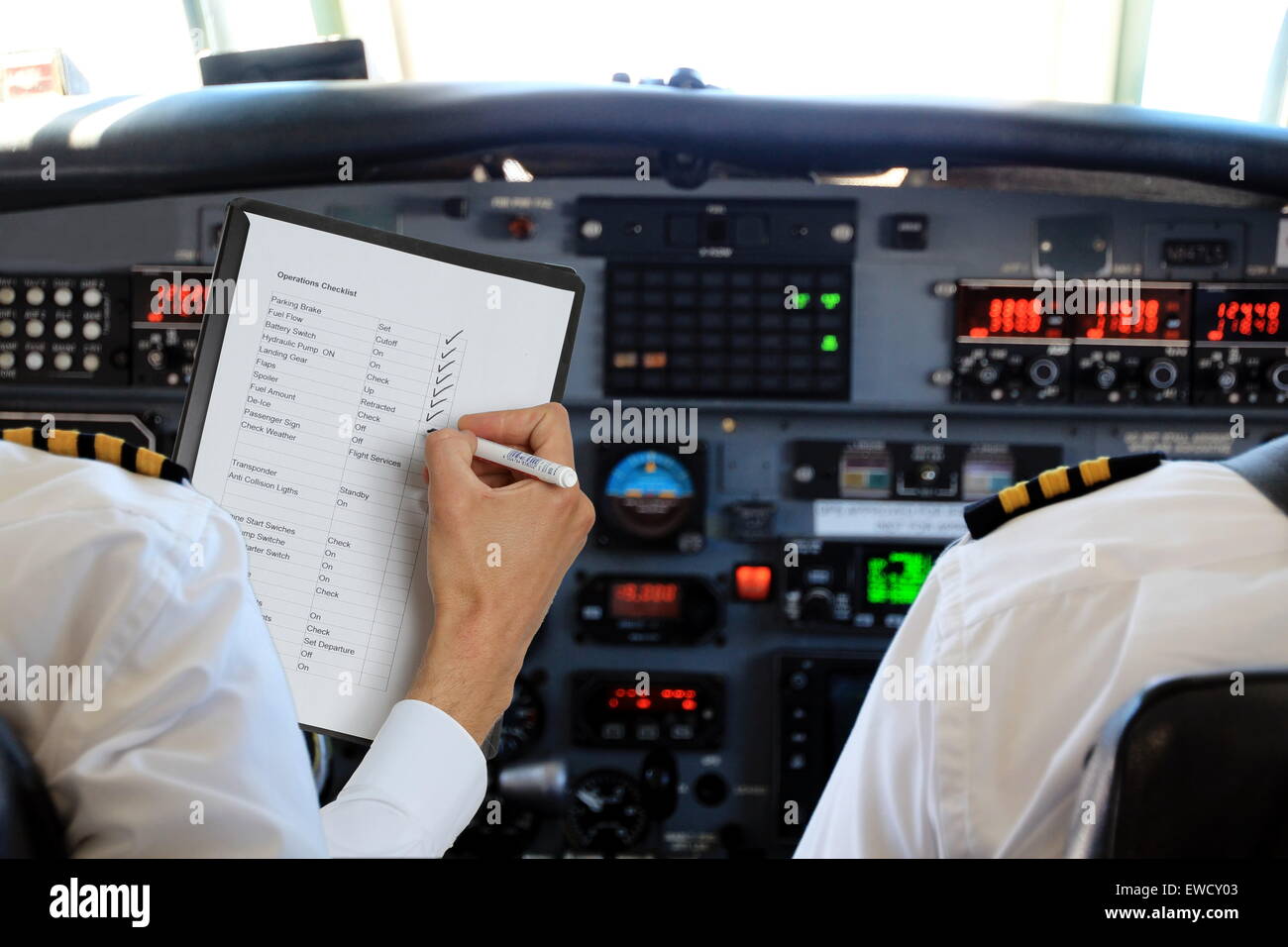 Two Pilots in aircraft with a checklist Stock Photo - Alamy