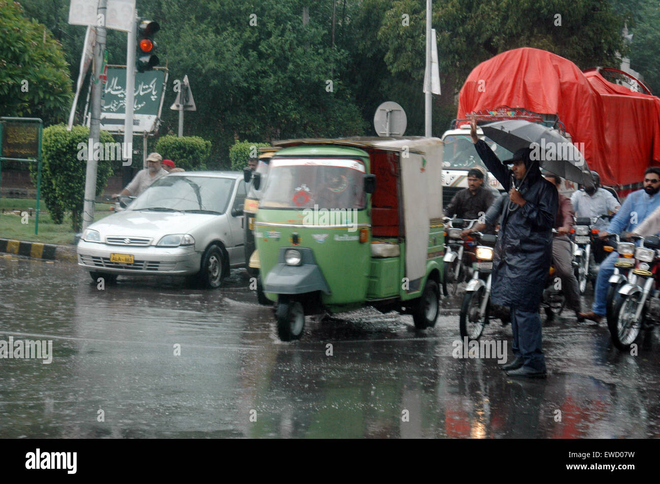 Lahore. 23rd June, 2015. A Pakistani policeman controls traffic during ... Lahore. 23rd June, 2015. A Pakistani policeman controls traffic during ...