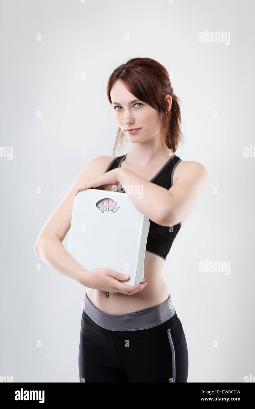 portrait of a young woman holding scales Stock Photo - Alamy