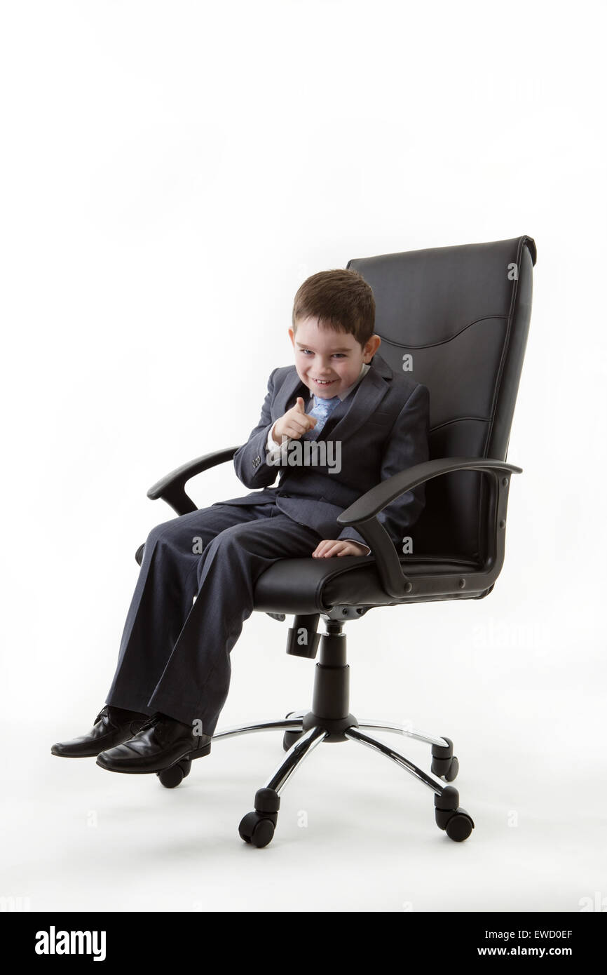 young boy sitting on a office chair pointing his finger Stock Photo - Alamy