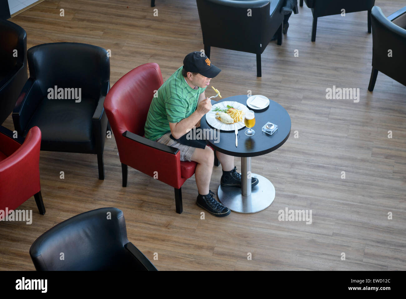 Overhead view of a man eating alone at a restaurant Stock Photo - Alamy