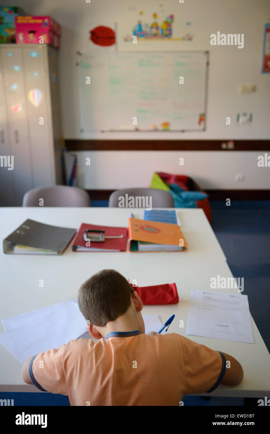 Rear view of a boy doing homework at home Stock Photo - Alamy