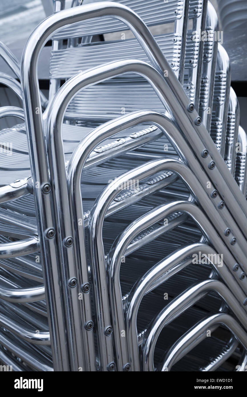 Shining metal chairs are stacked in a outdoor cafeteria Stock Photo - Alamy