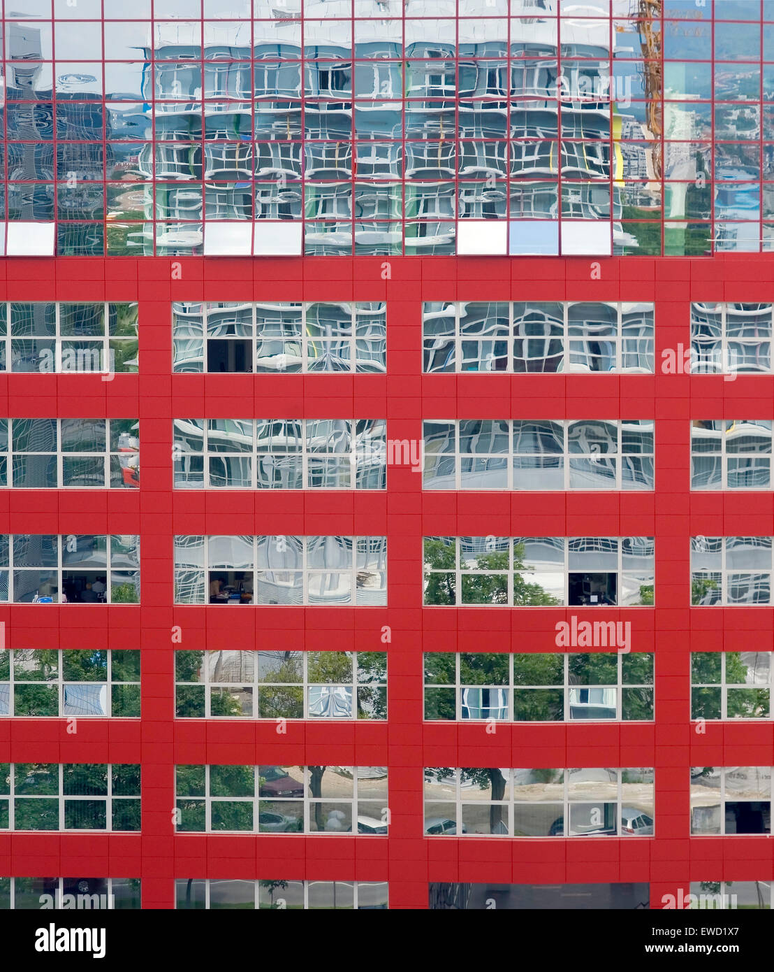 Red building with reflective office window Stock Photo - Alamy