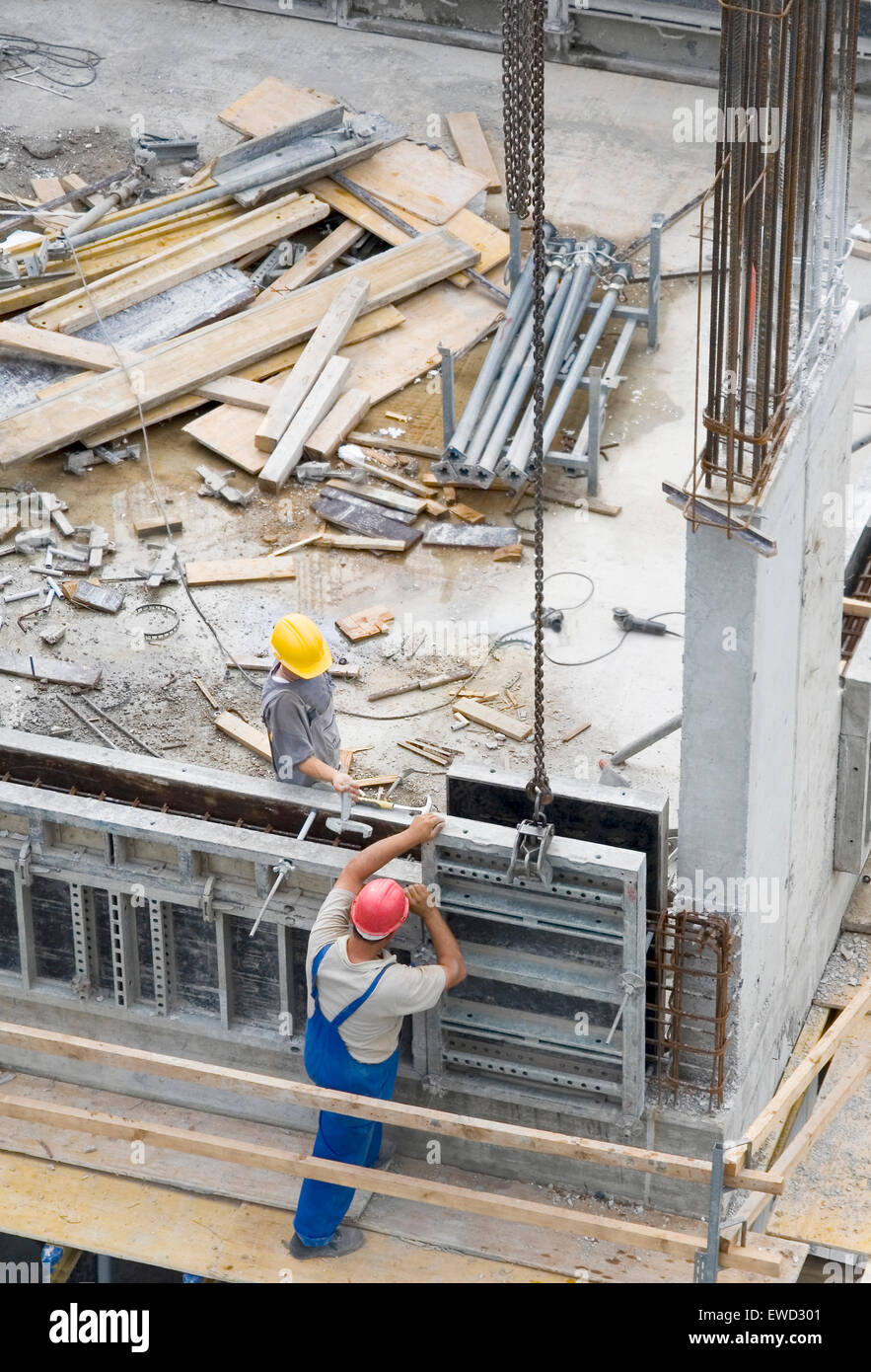 Construction workers on the building site Stock Photo - Alamy