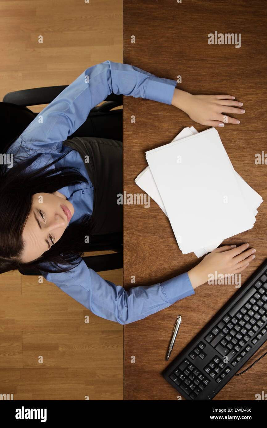 woman typing and working hard at her desk taken from a birds eye view ...