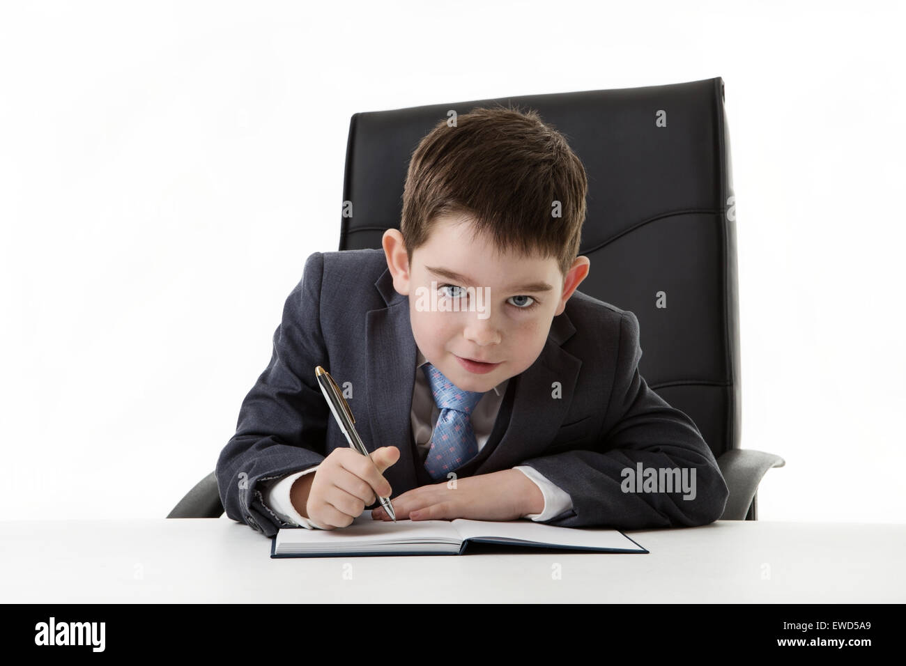 young small boy pretending he's working in an office working hard Stock ...