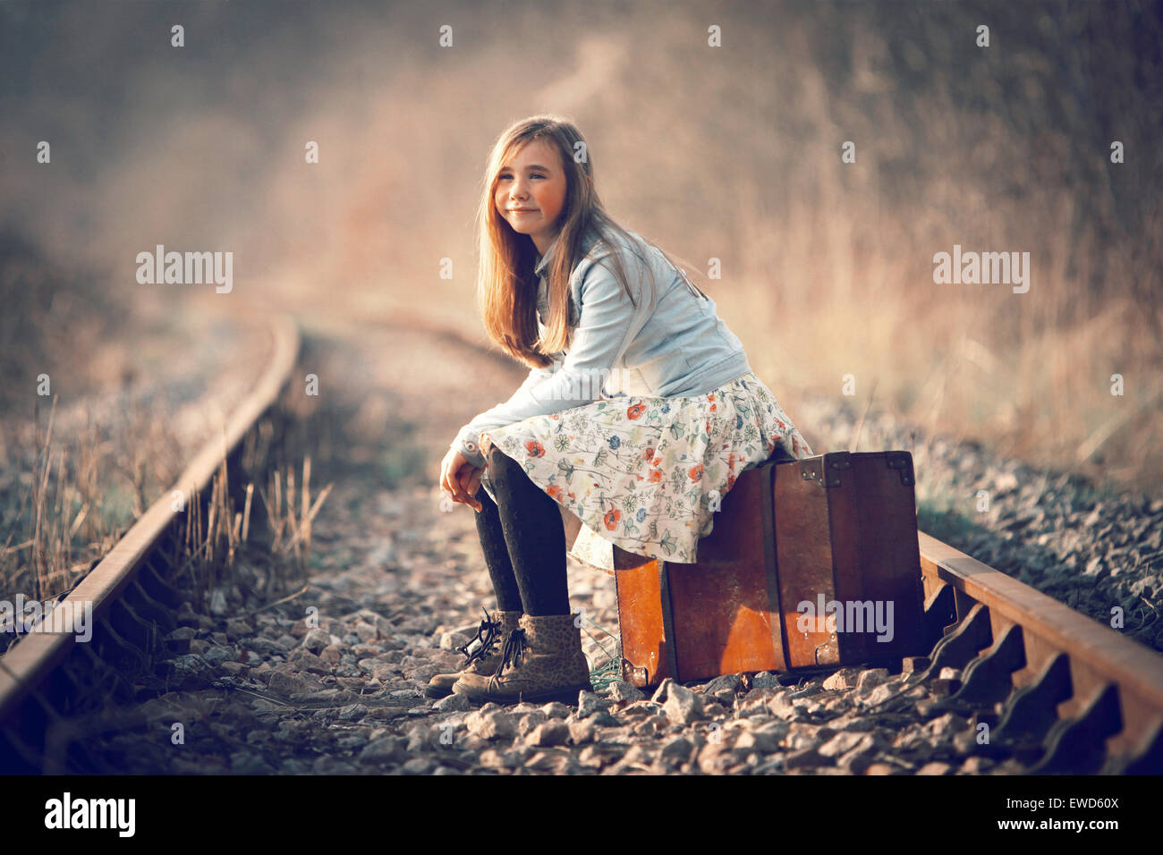 Runaway girl has fun on an unused country railway track Stock Photo - Alamy