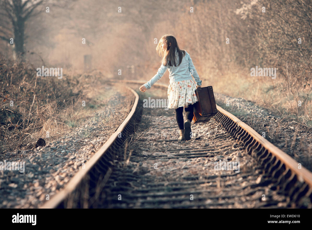 Runaway girl has fun on an unused country railway track Stock Photo - Alamy