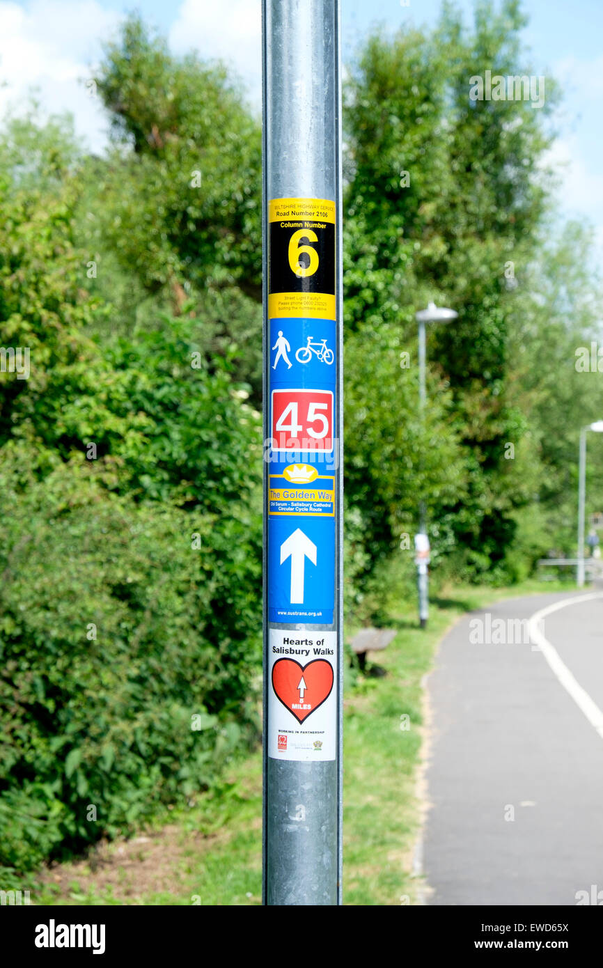 Cycling and walking information stickers on a metal lamp post at the ...