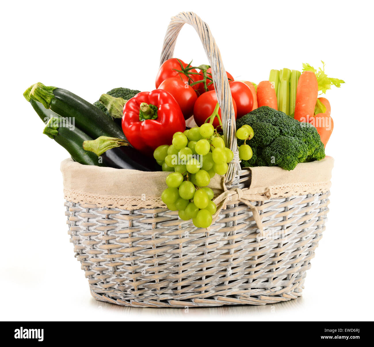 Variety of organic vegetables and fruits in wicker basket isolated on ...
