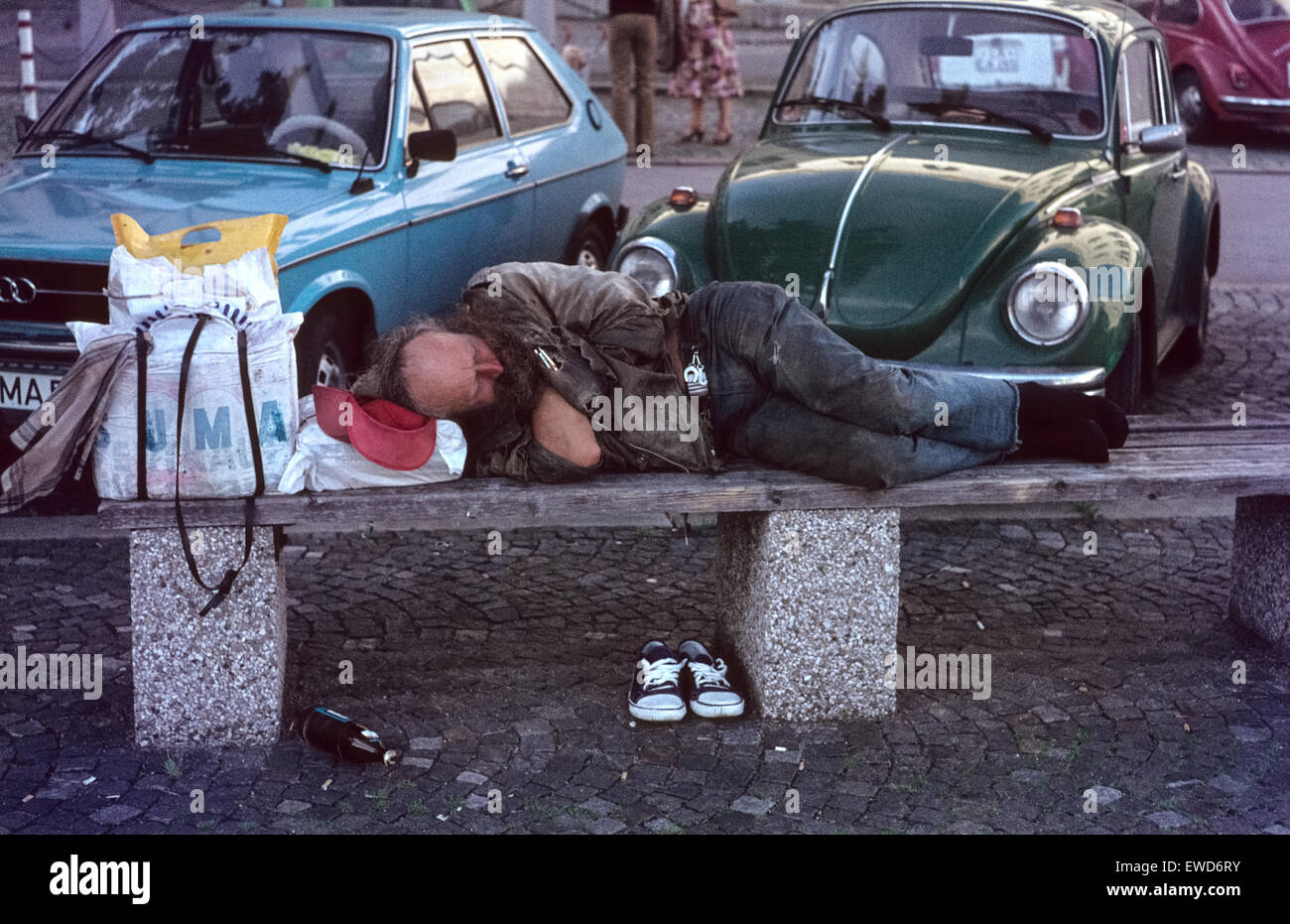 Homeless man sleeping on a bench in front of the university Munich 1978 ...