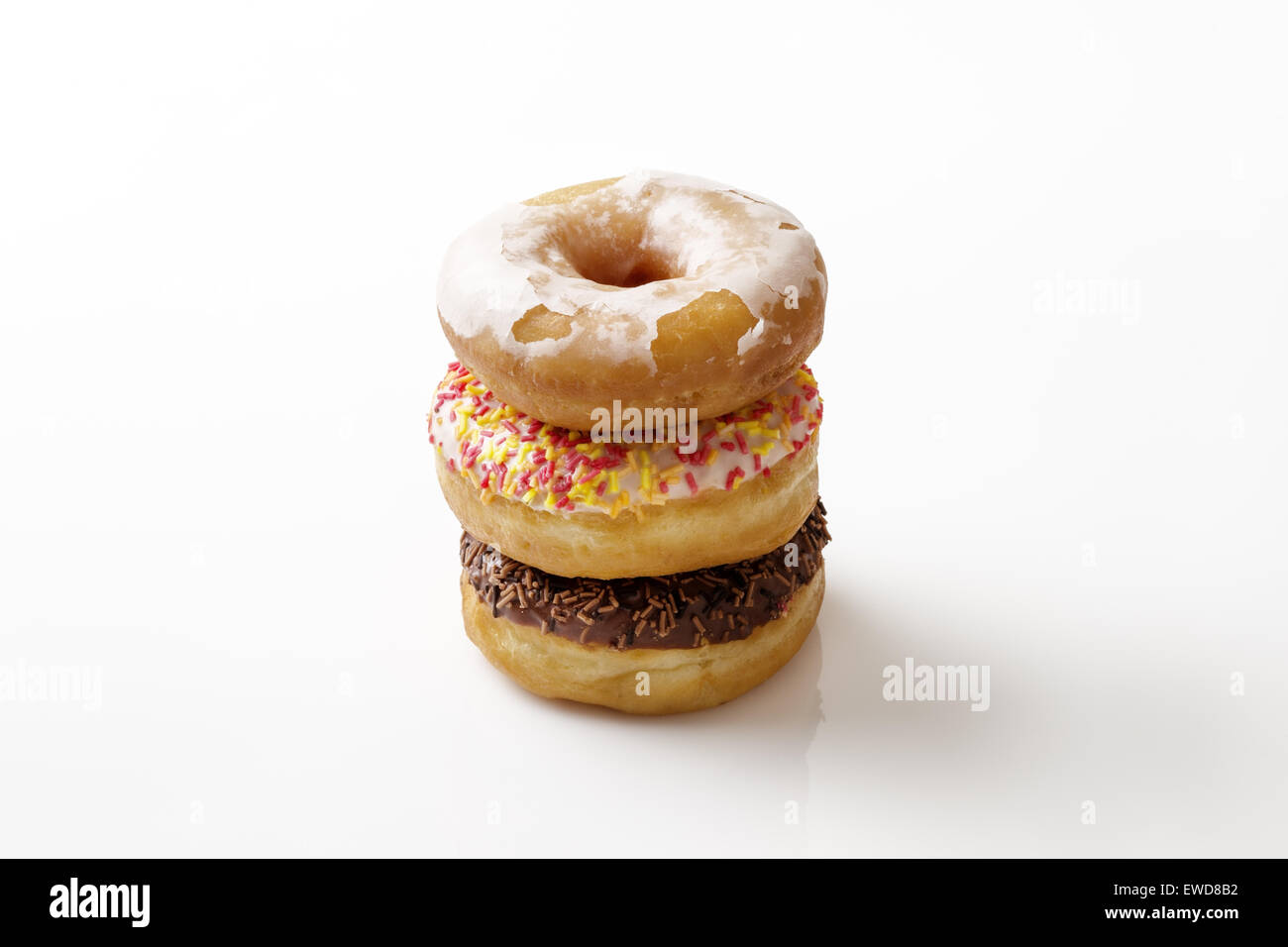 stack of three donuts on plain white background shot in the studio ...