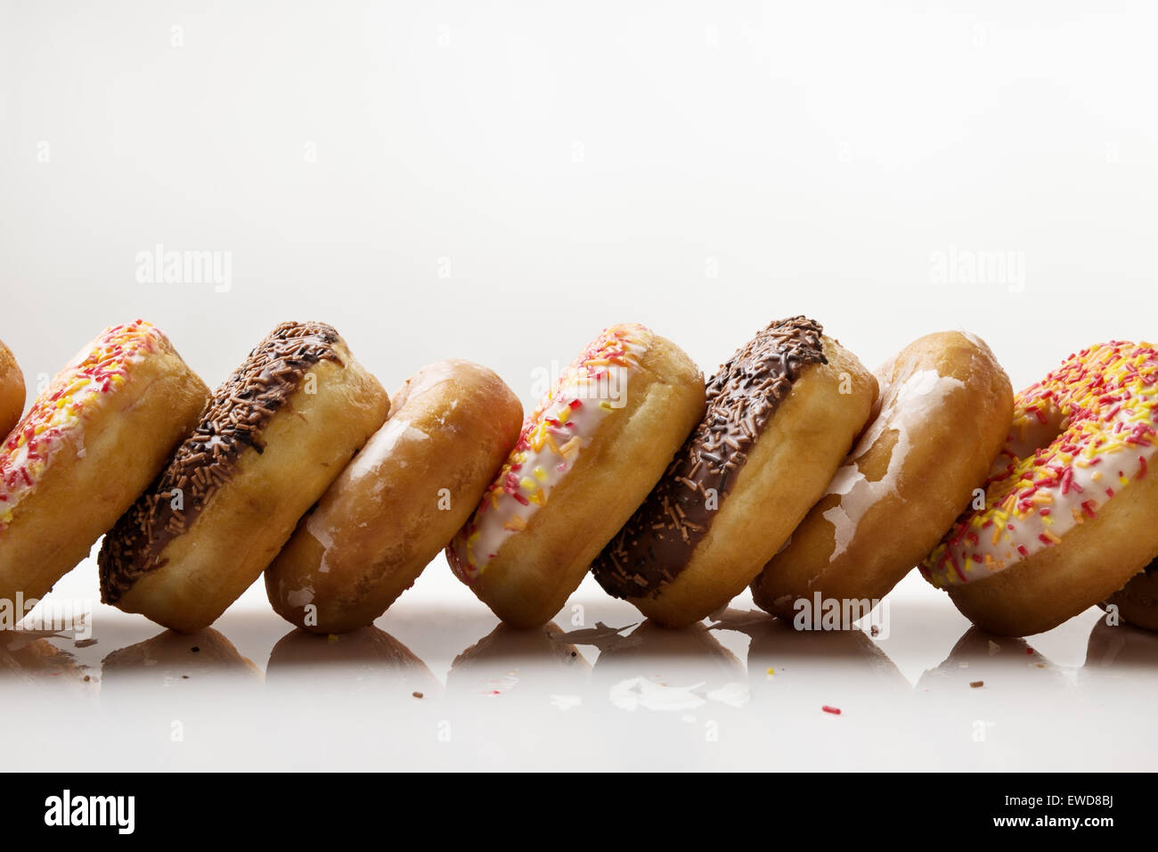 row of donuts on white background Stock Photo - Alamy
