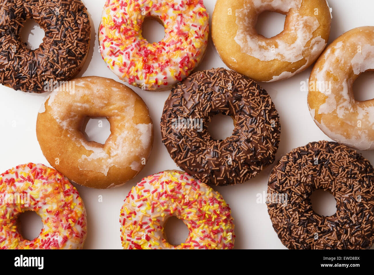 large selection of donuts, many different flavors, shot on white ...