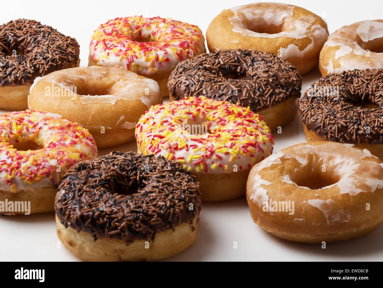 large selection of donuts, many different flavors, shot on white ...