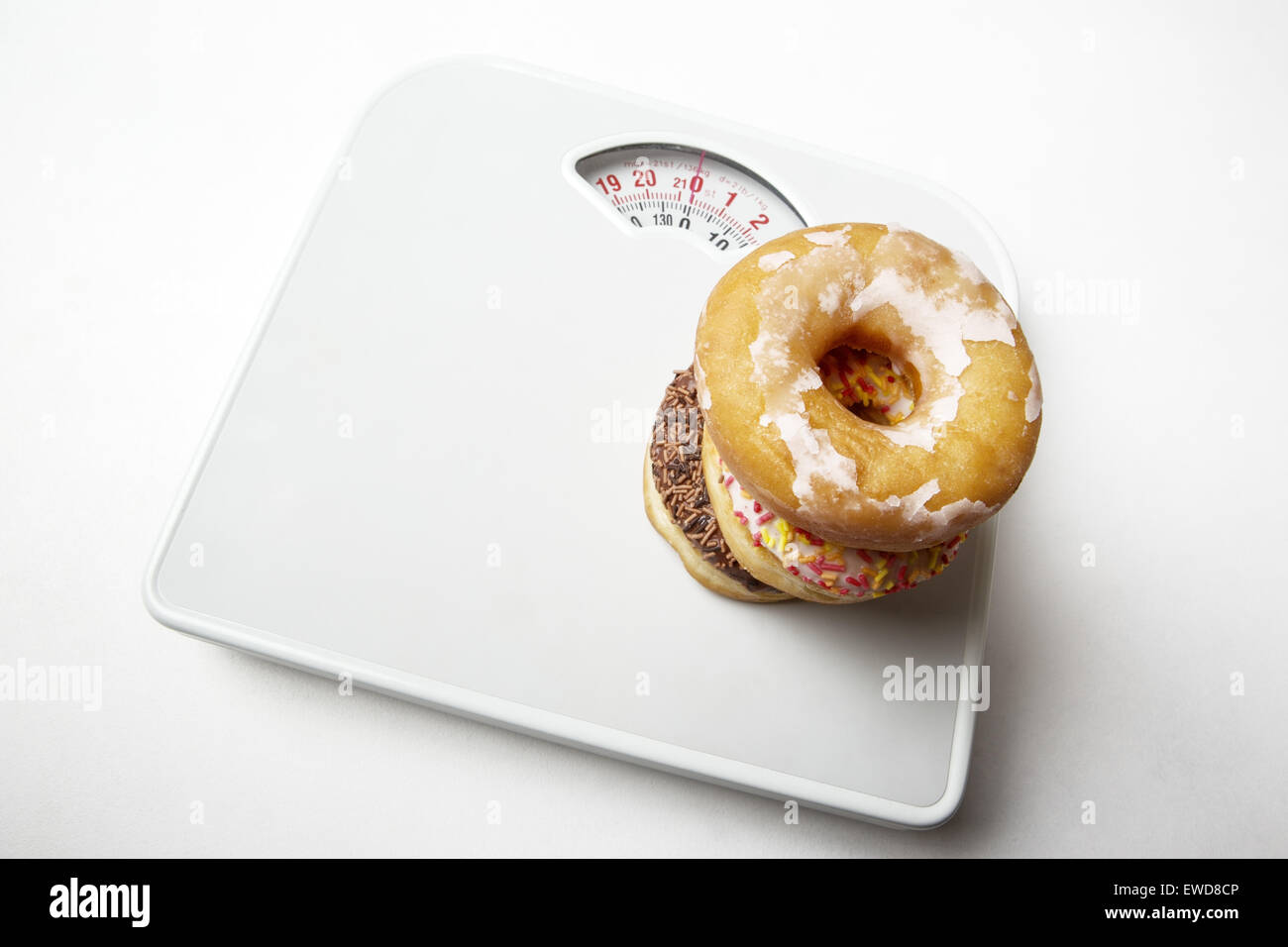 stack of different flavor donuts shot on scale for weighing yourself ...