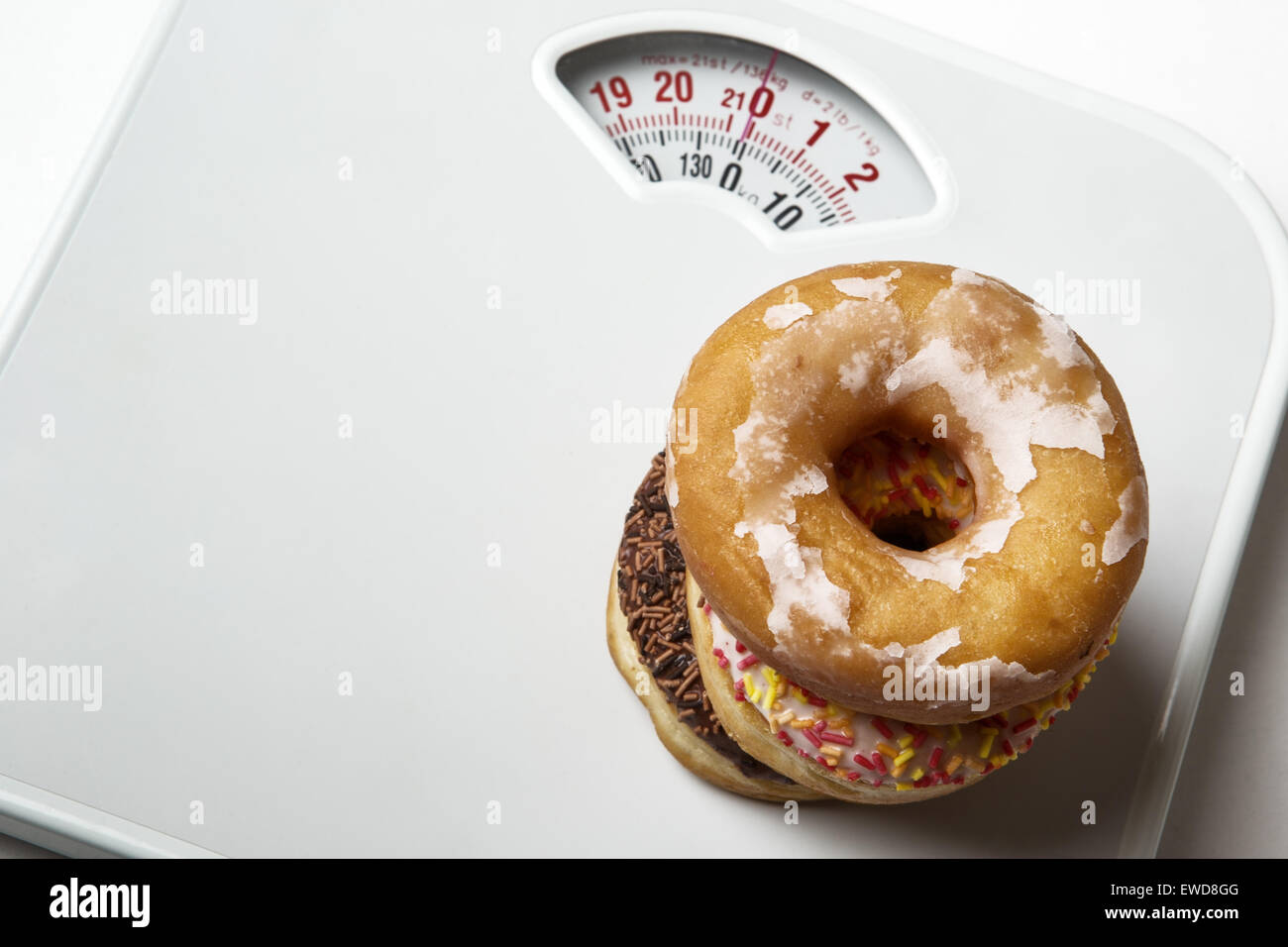 stack of different flavor donuts shot on scale for weighing yourself ...