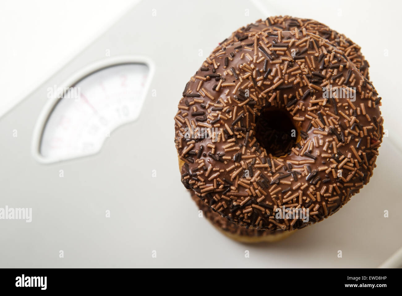 stack of different flavor donuts shot on scale for weighing yourself ...