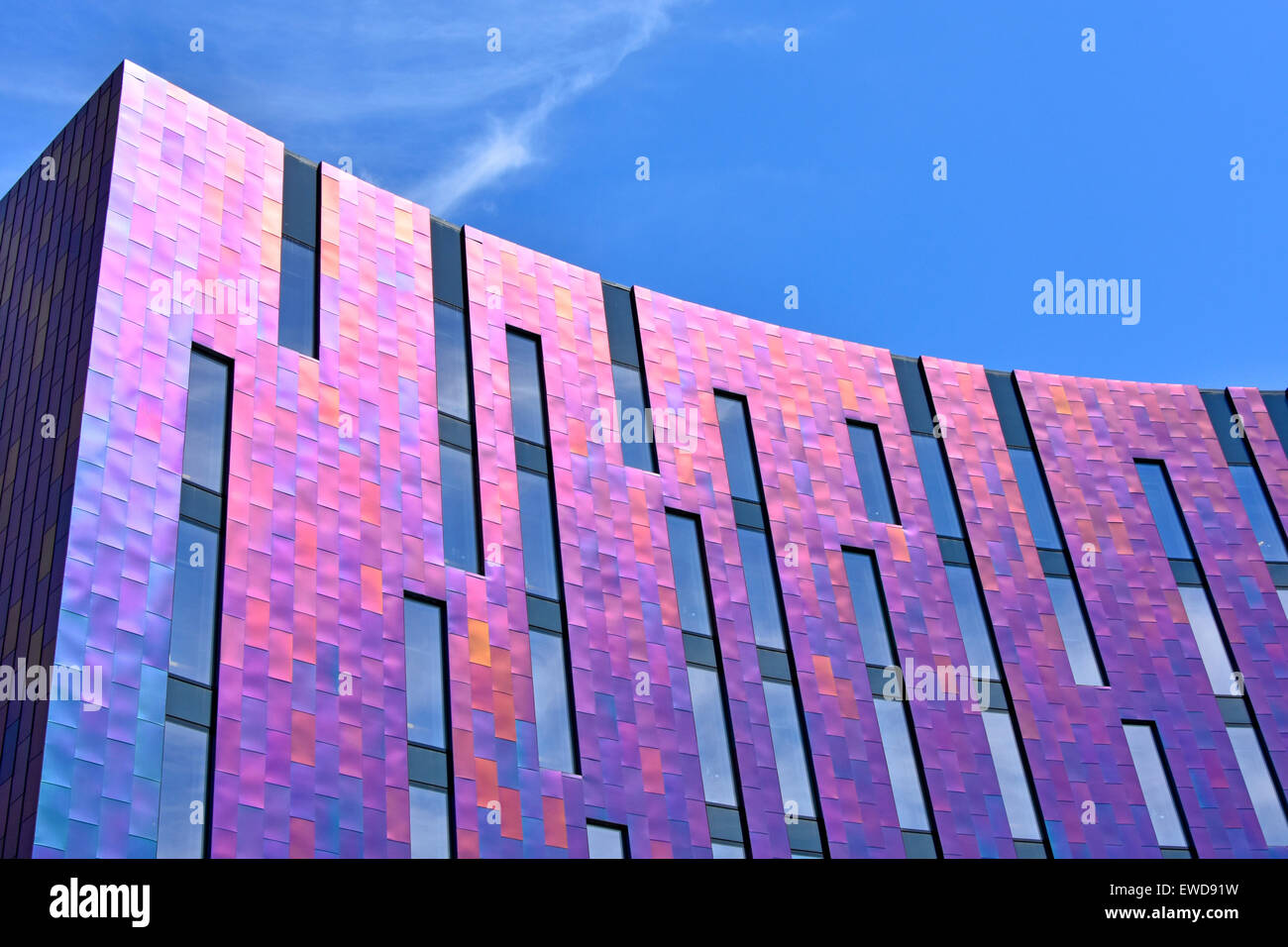 Abstract pattern of colourful cladding and glazing panels reflecting ...