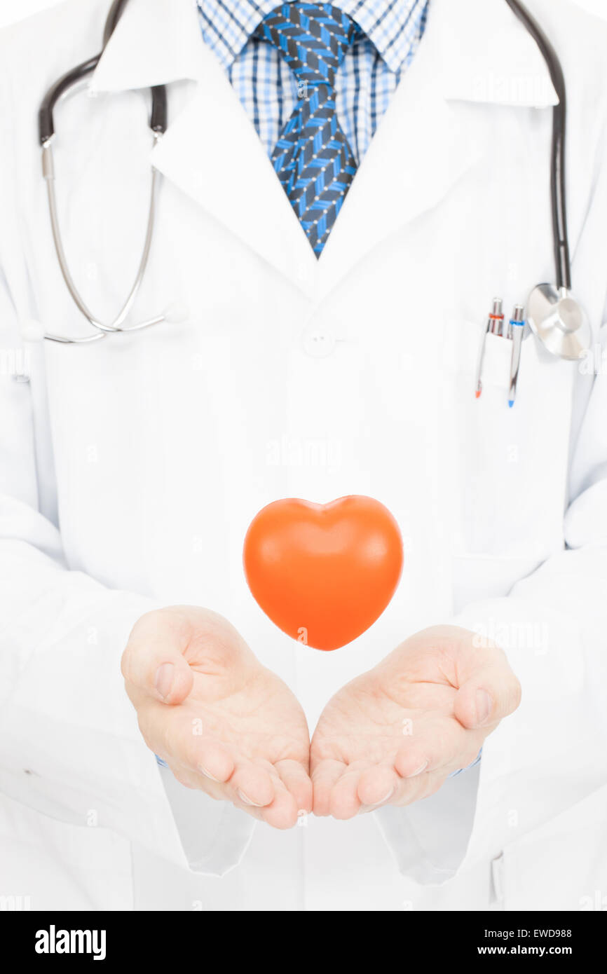 Toy heart floating in air over doctors palms Stock Photo - Alamy