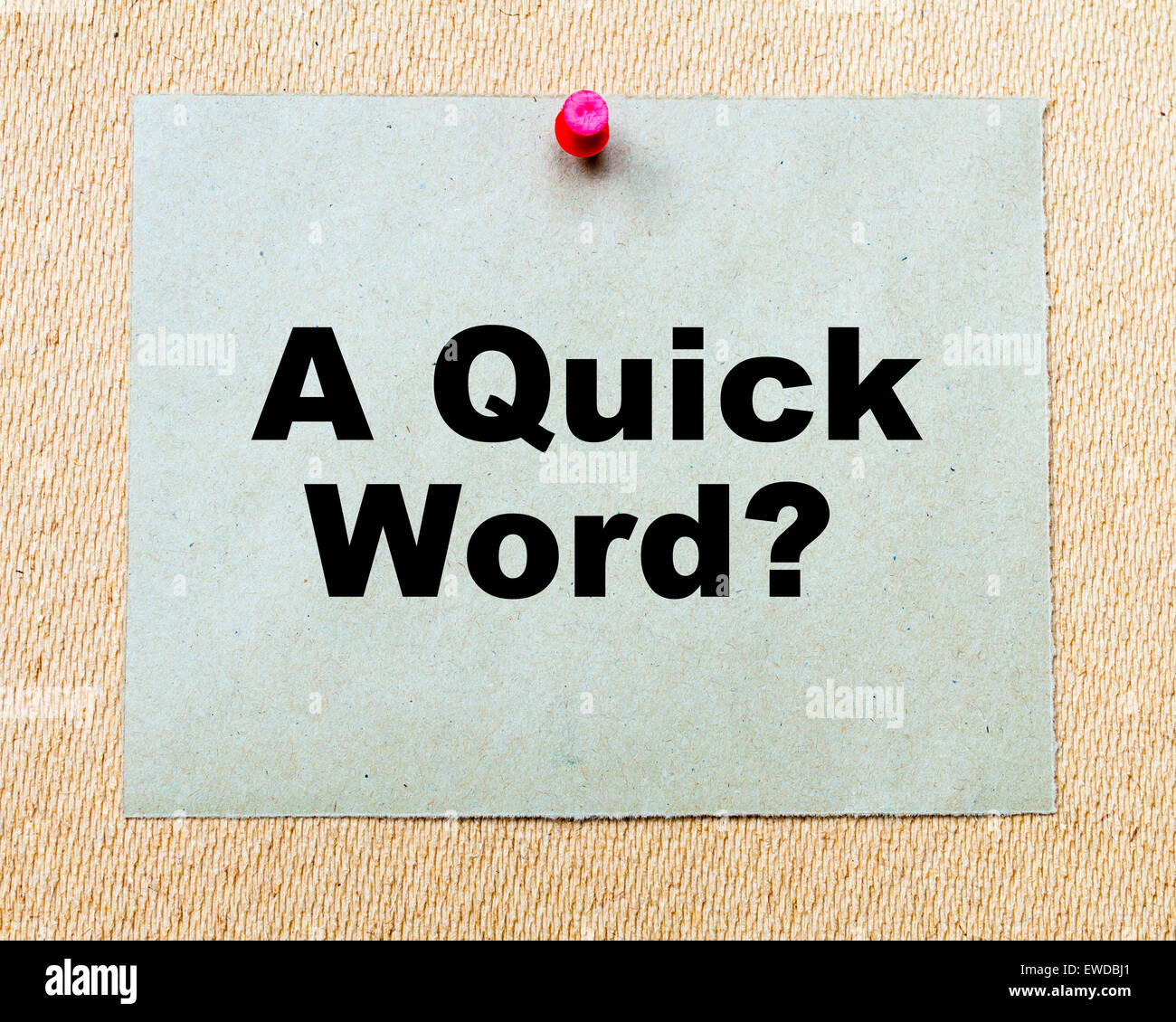 A Quick Word? written on paper note pinned with red thumbtack on wooden ...