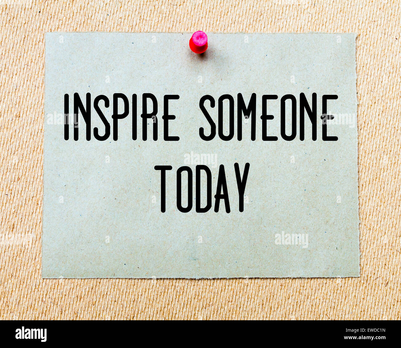 Inspire Someone Today written on paper note pinned with red thumbtack ...