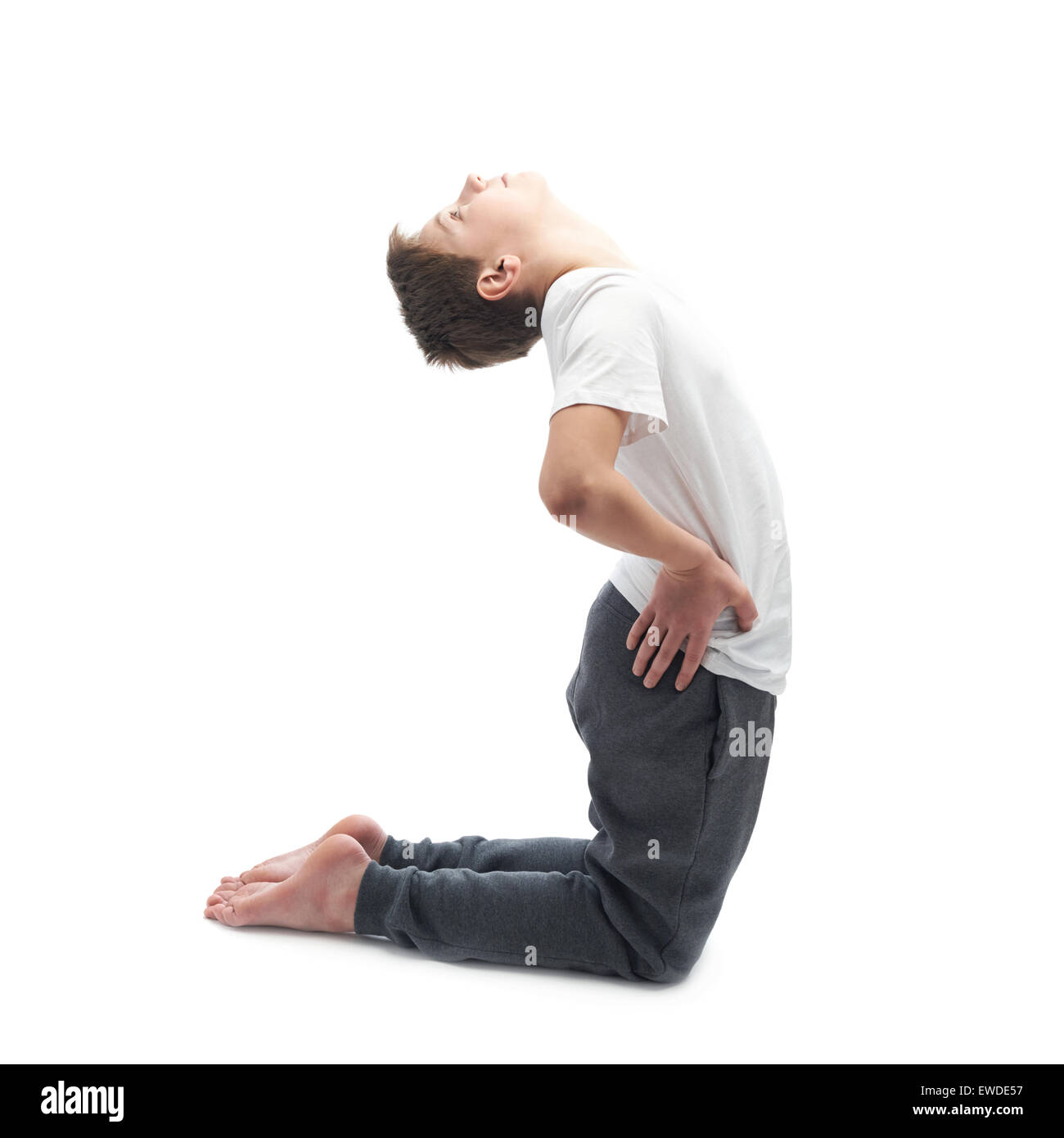 Young boy stretching or doing yoga Stock Photo - Alamy