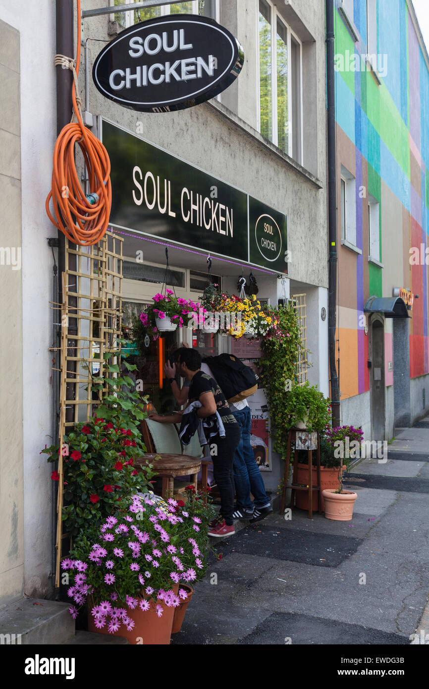 Two people looking into the Soul Chicken restaurant in the old town of ...