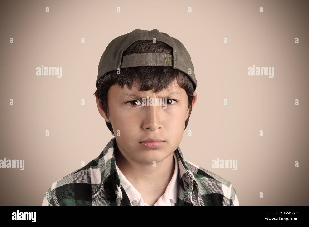 Portrait of young serious cross boy with vintage look and vignetting ...