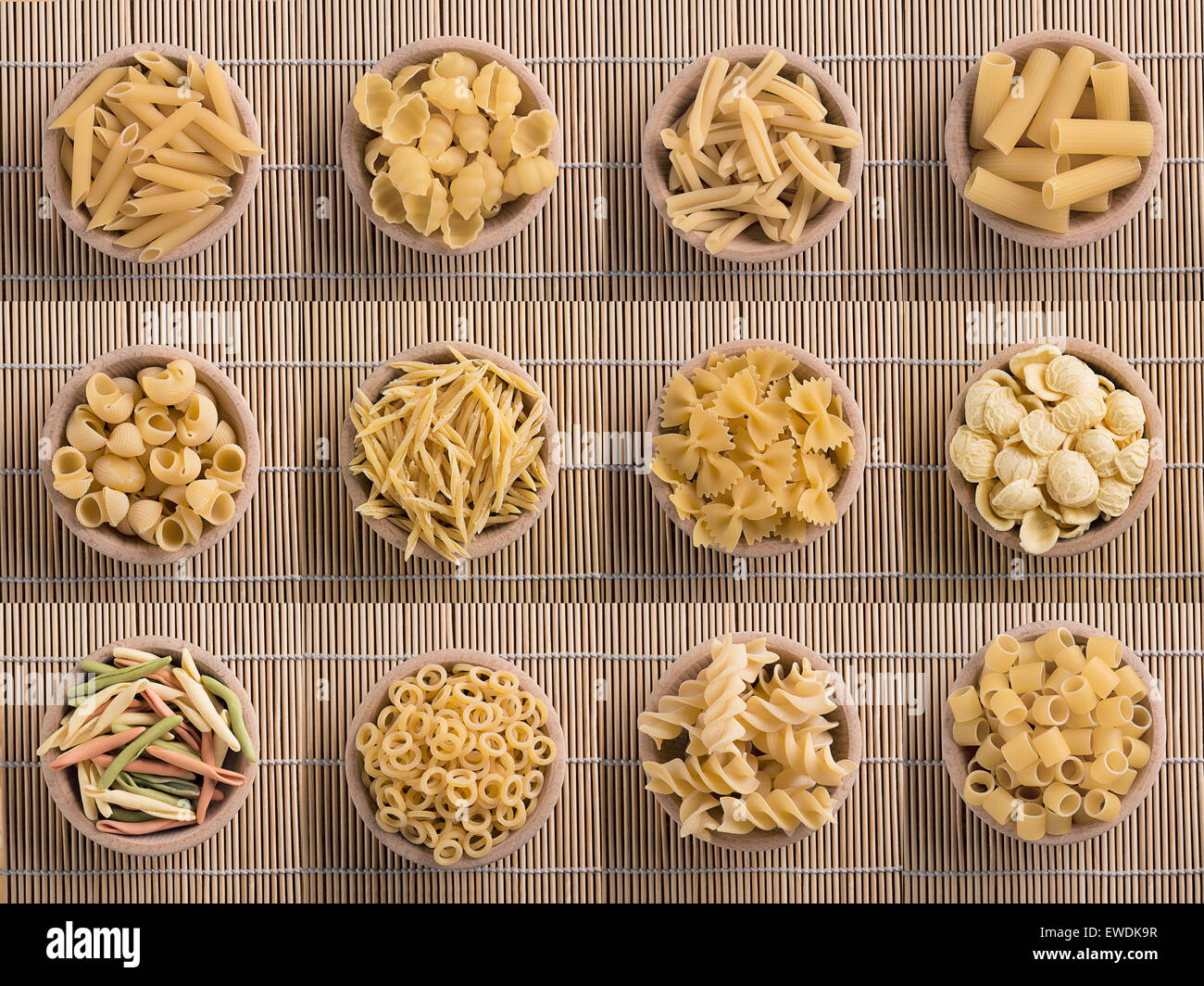 typical Italian dish various types of raw pasta in a wooden bowl Stock ...