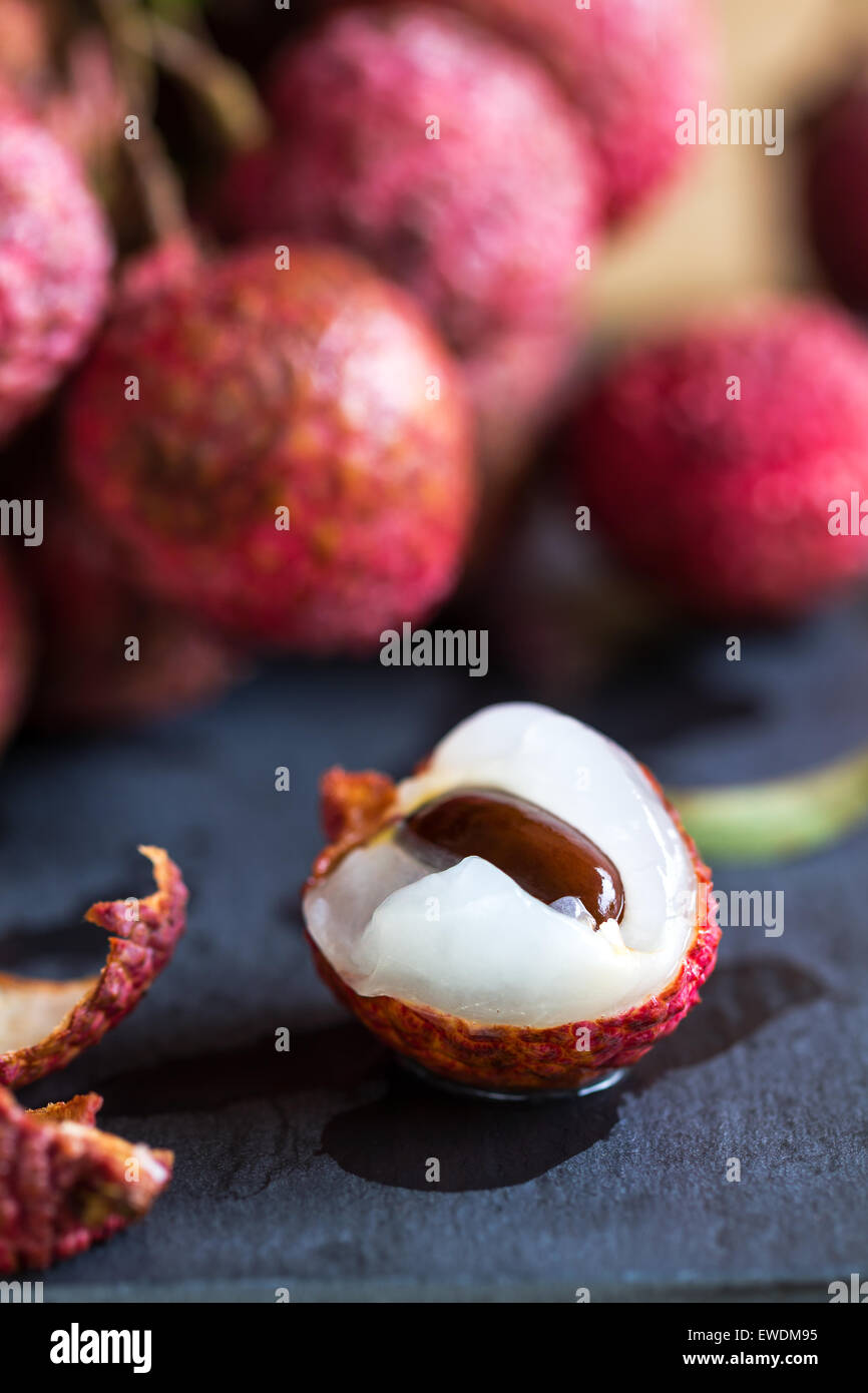 Fresh bunch of Lychees on wooden table Stock Photo - Alamy