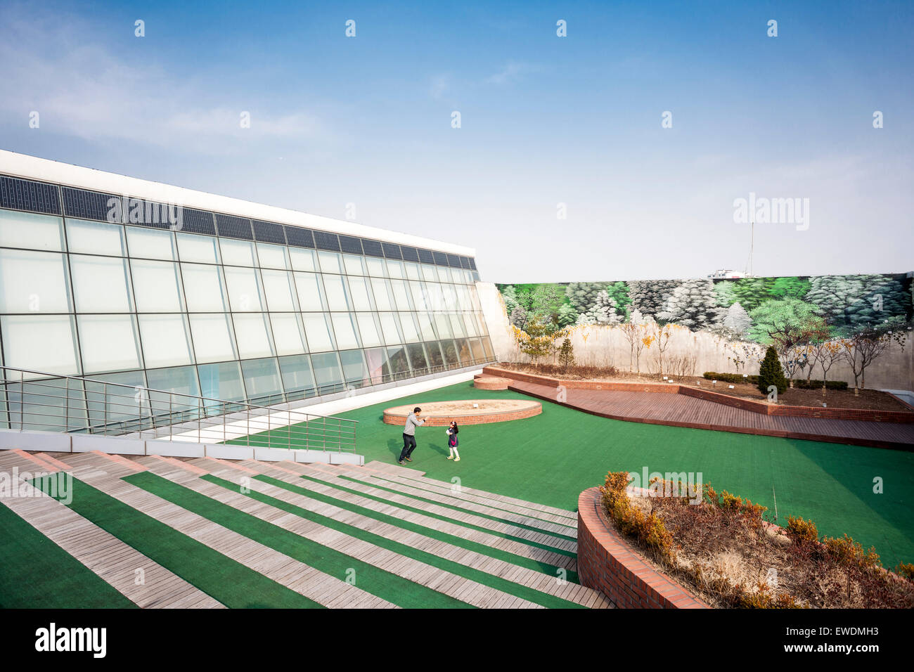 A man and his daughter playing on the roof terrace. Incheon Children ...