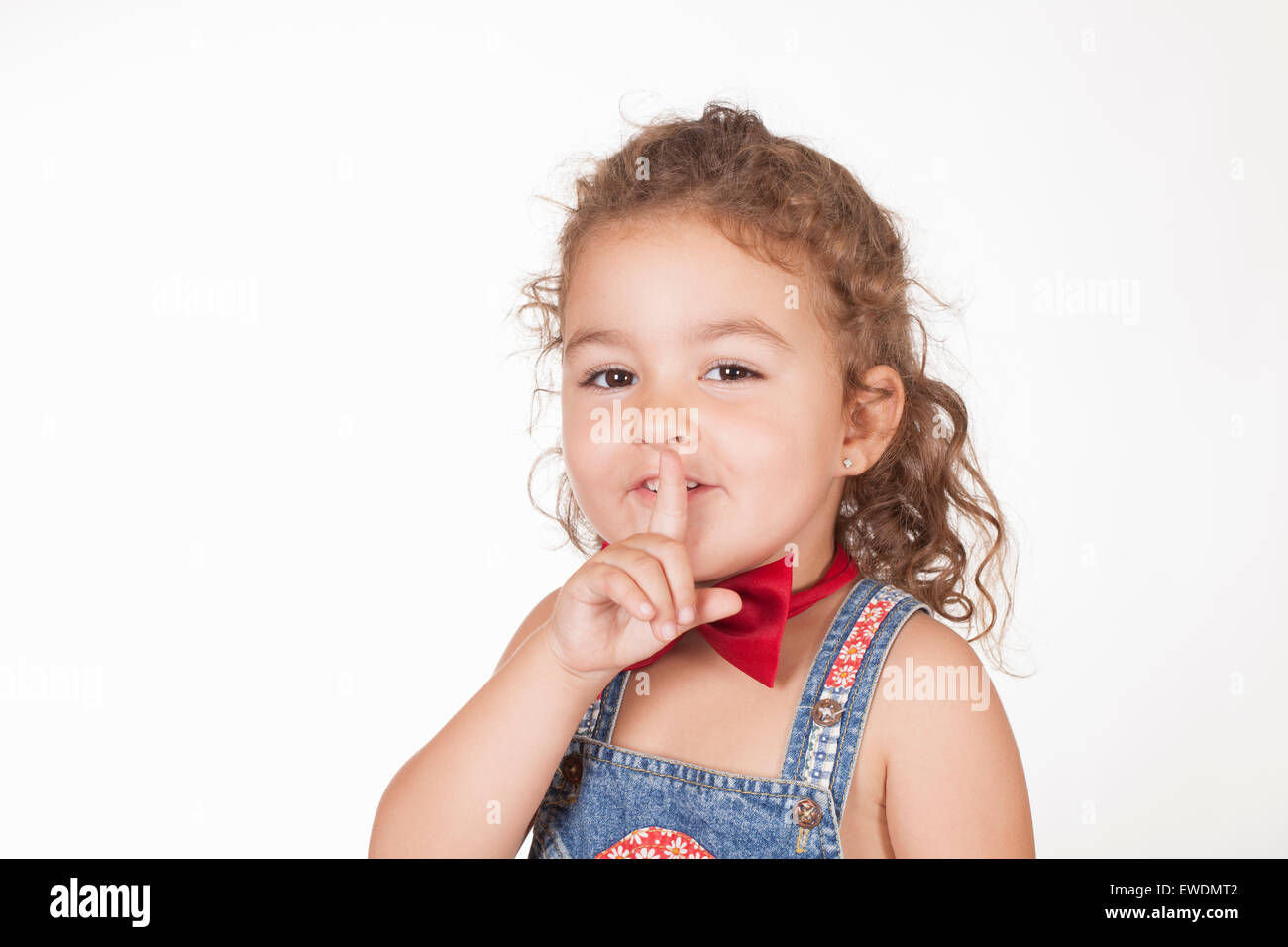 a pretty little girl making silence sign Stock Photo - Alamy