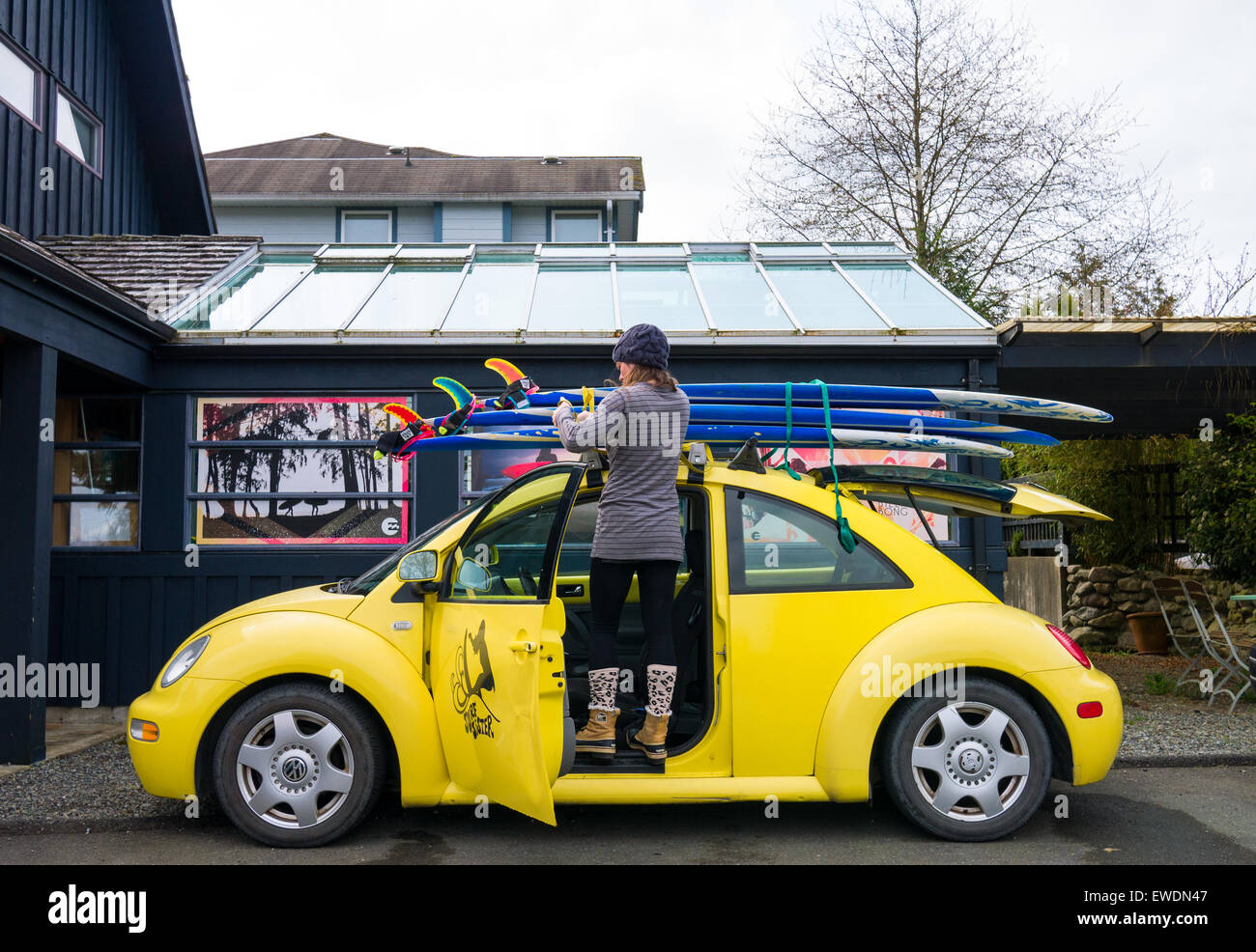 A surfer gets ready to head to the beach in Tofino, British Columbia ...