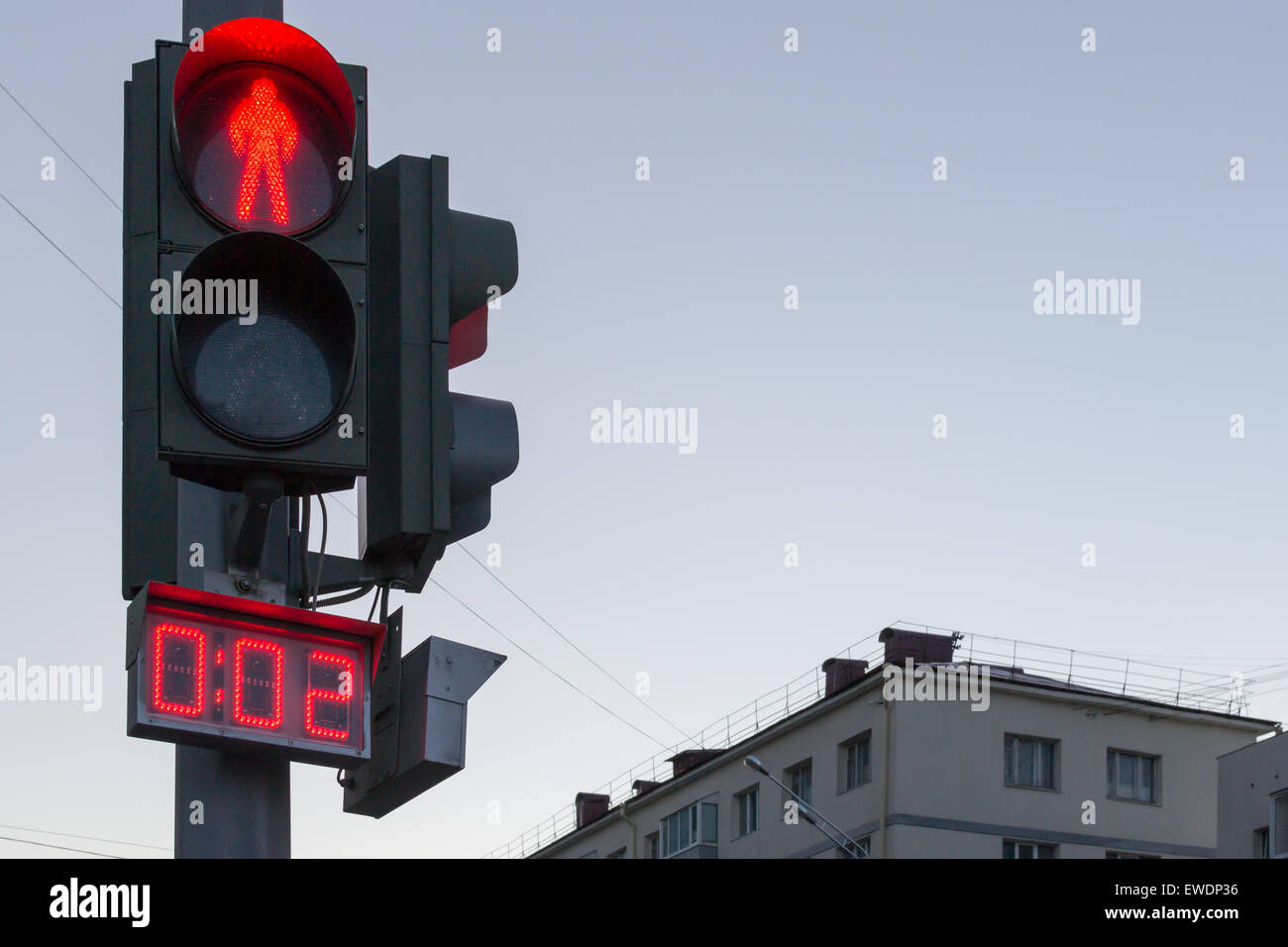 Red neon stop sign for pedestrians against buildings and sky Stock ...