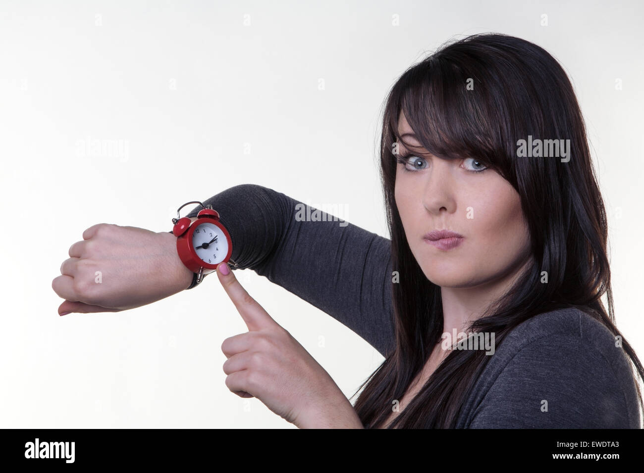 woman looking at here wrist watch late for a something Stock Photo - Alamy