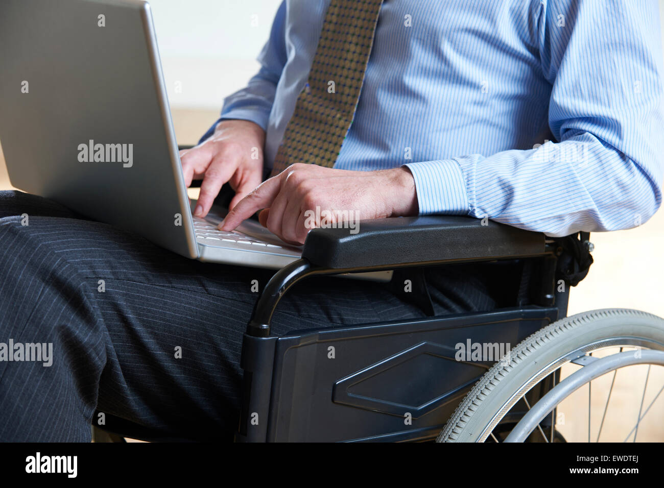 Disabled Businessman In Wheelchair Using Laptop Stock Photo - Alamy