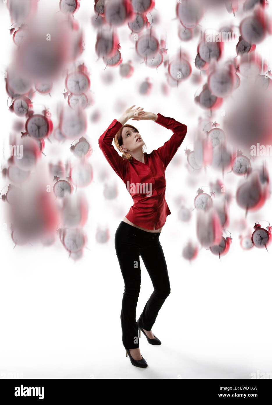 standing woman with arms up above her head protecting her self from ...